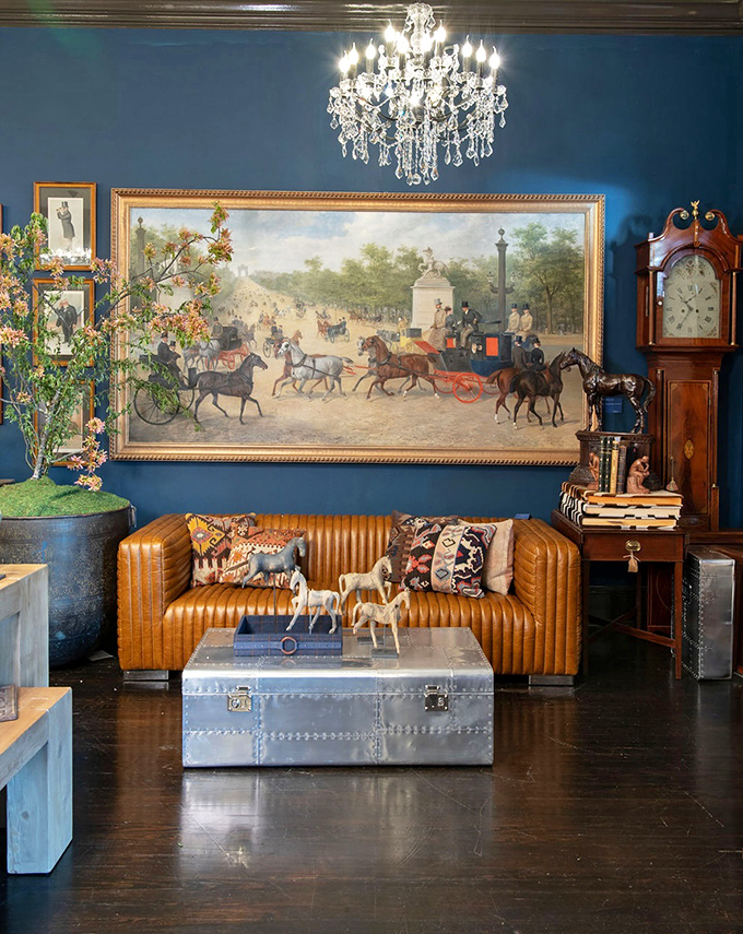 A living room that never lived in a home, yet feels more alive than most. That equestrian painting above the leather sofa practically echoes with hoofbeats.
