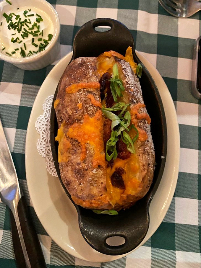 A loaded baked potato that's dressed to impress, wearing its cheese and toppings like jewelry at the potato prom.