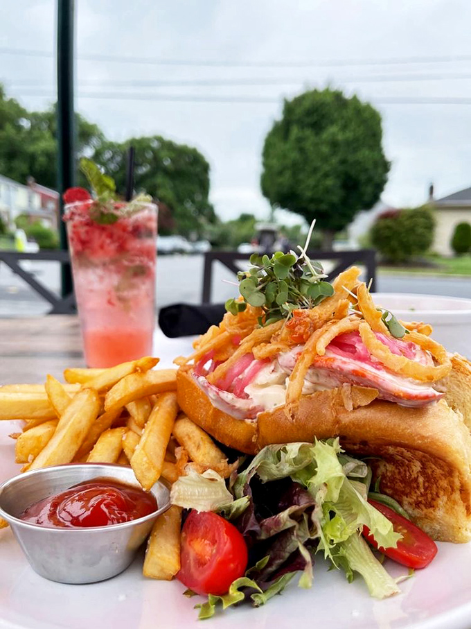 This isn't just a lobster roll—it's summer vacation on a plate. Chunks of sweet lobster meat nestled in a toasted roll with crispy fries alongside.