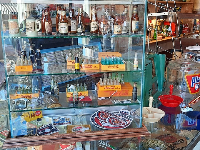 Coca-Cola's iconic red brightens these vintage treasures. Each bottle and crate tells a story of American refreshment through the decades.