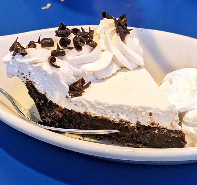 Mississippi mud pie that makes you consider ordering dessert first. That mountain of whipped cream isn't just decoration&mdash;it's a life philosophy.
