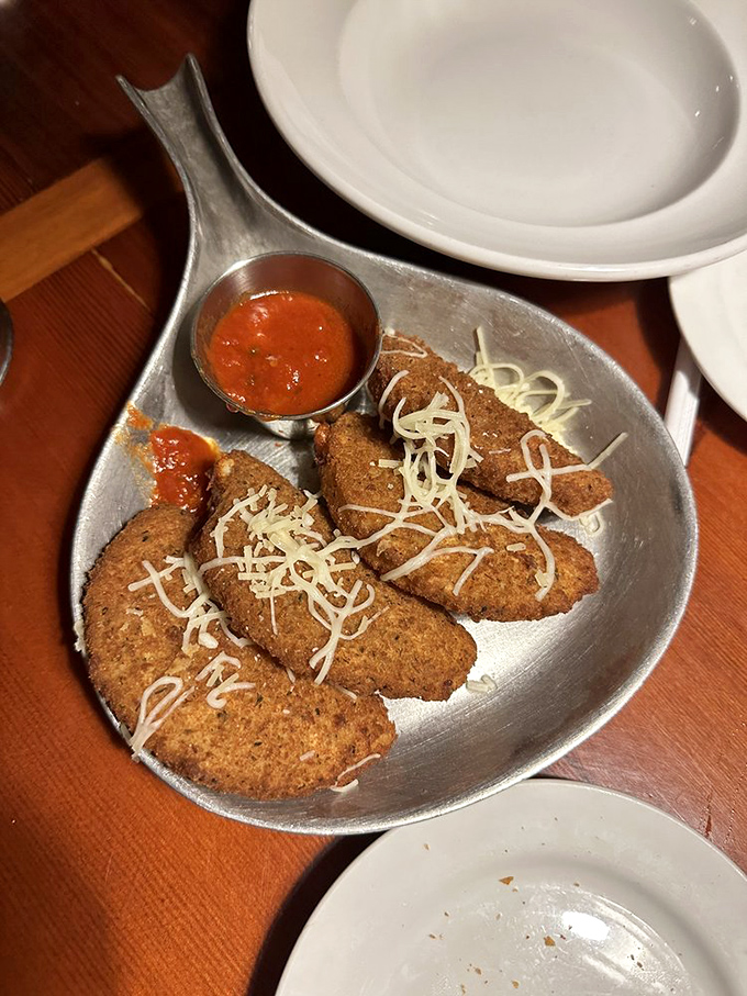 Mozzarella moons that orbit your plate like cheesy satellites, waiting to be dipped in that vibrant marinara solar system. Space never tasted so good.
