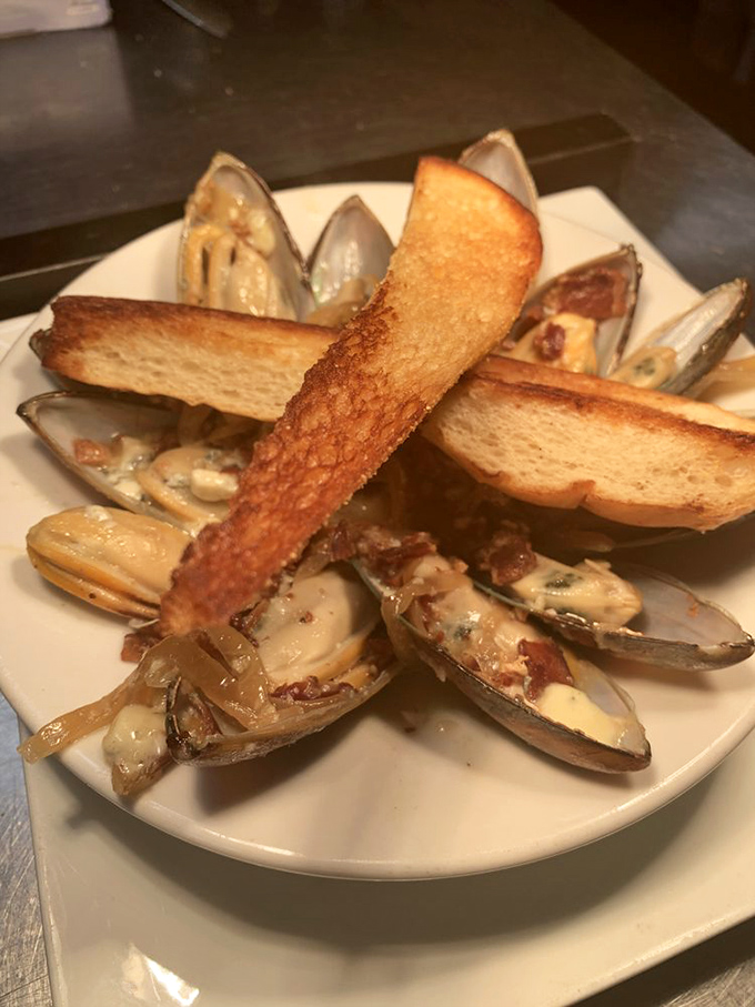 These mussels aren't just served&mdash;they're presented like the seafood royalty they are. The toasted bread stands ready to soak up that ambrosial broth.