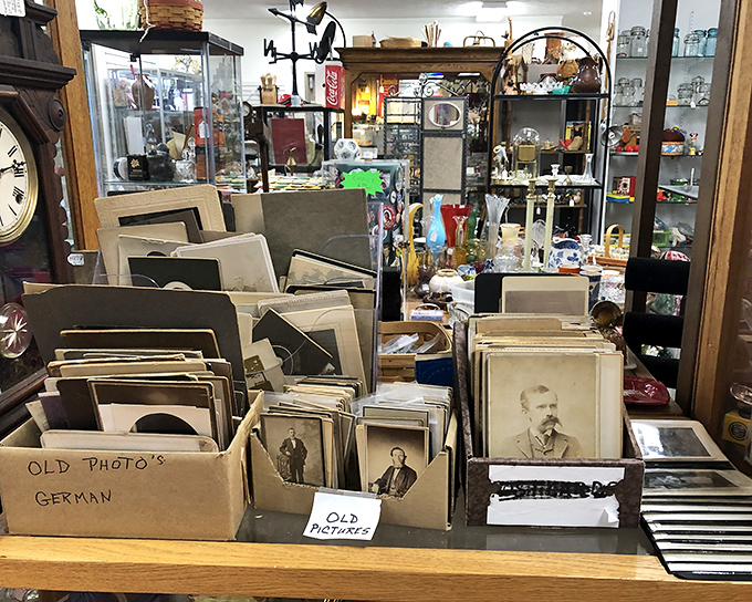 Faces from another century stare back from these sepia-toned photographs, their expressions timeless despite their antiquated surroundings.