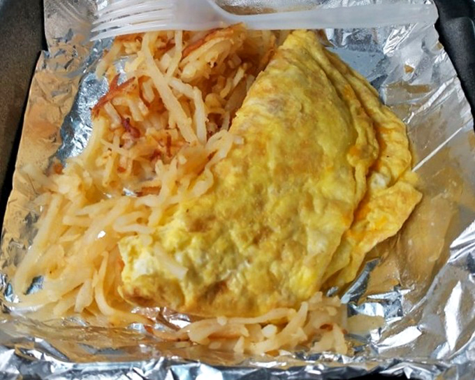 Breakfast's greatest hits on one plate. That perfectly folded omelet is hiding treasures within, while the hash browns provide crispy contrast.