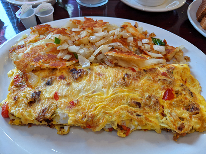 An omelet so fluffy and cheese-laden it should come with its own warning label: "May cause spontaneous breakfast happiness."