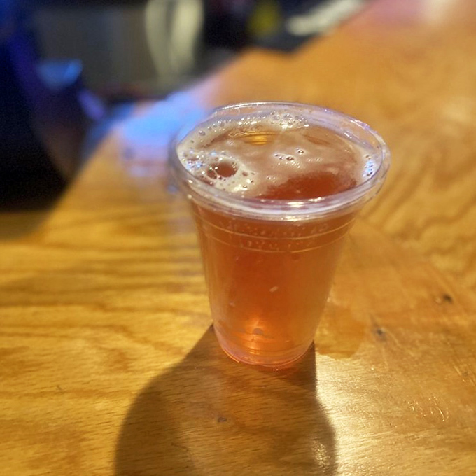 Nothing says "vacation mode activated" like a cold brew in a plastic cup while contemplating your next seafood conquest.