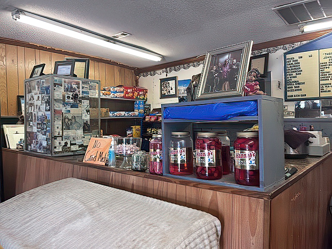 The heart of operations where burger magic happens. No-frills counter service with family photos and jars of pickled treasures standing guard.