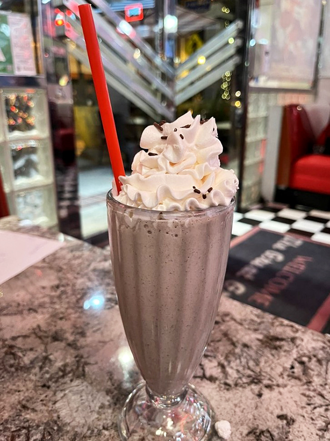 An Oreo shake topped with whipped cream that defies gravity. The straw stands at attention, awaiting your first transcendent sip of cookies-and-cream heaven.
