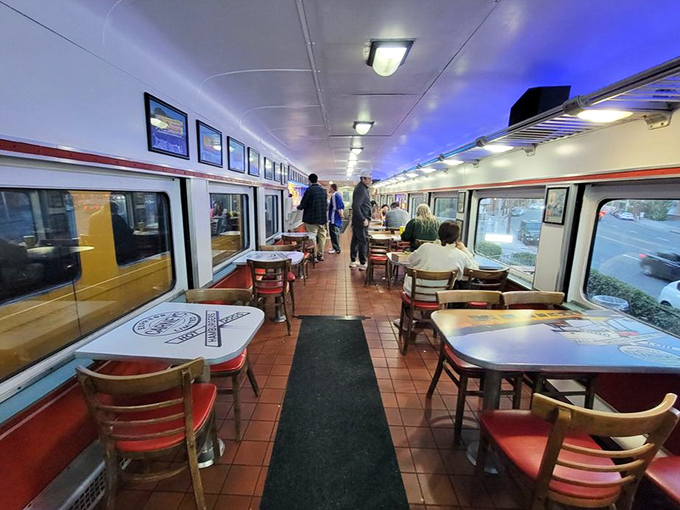 The classic train car interior with its red accents and wooden chairs feels like stepping into a simpler time when food was just food – gloriously delicious food.