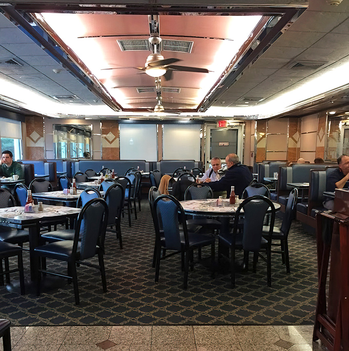 Another dining area where blue chairs and patterned carpet have witnessed countless birthday celebrations, business deals, and first dates.