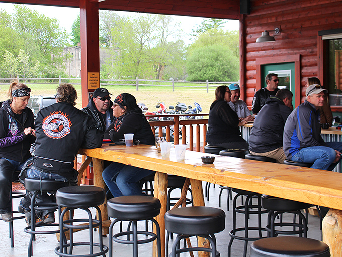The outdoor patio where bikers, locals, and lost tourists come together under colorful umbrellas to celebrate the universal language of smoked meat.