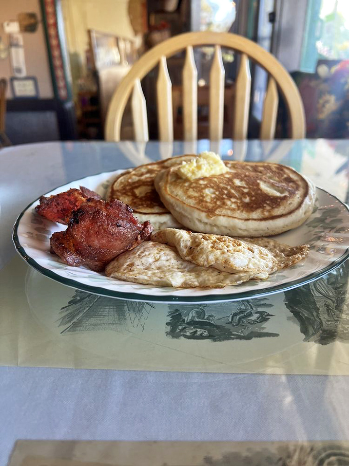 Pancakes so fluffy they practically hover above the plate, joined by eggs and bacon in a breakfast trinity that's worth setting the alarm for.