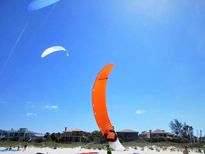 Kiteboarding against an impossibly blue sky. Some visitors prefer adrenaline with their vitamin D&mdash;Florida's version of extreme sports!