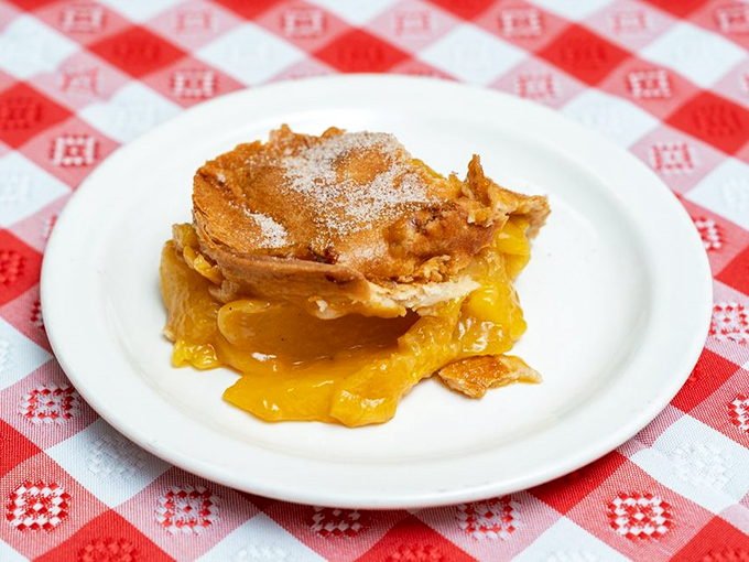 This peach cobbler isn't just dessert&mdash;it's the sweet finale to a smoky symphony, oozing with fruit and nostalgia.