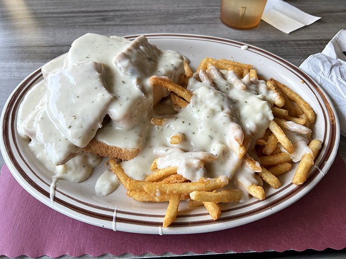 Gravy isn't just a topping here; it's practically a philosophical statement. This open-faced sandwich with fries doesn't just feed you&mdash;it hugs you from the inside out.