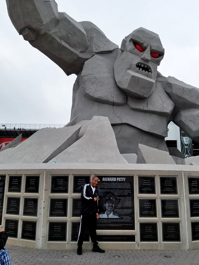 Don't mind me, just checking out these plaques. Racing history meets monster mythology beneath Miles' watchful gaze.