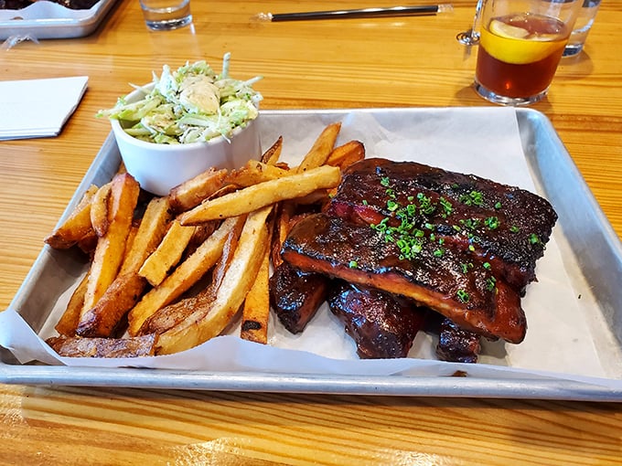 Ribs so tender they practically leap off the bone, paired with fries that know their supporting role perfectly.