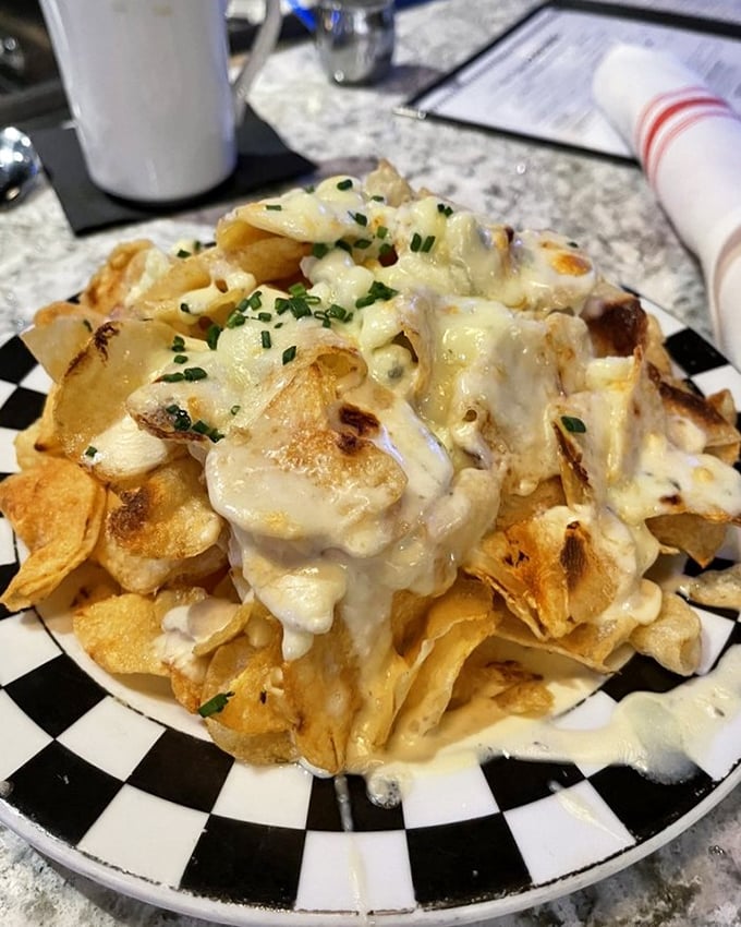 Potato chips ascend to art form when smothered in Alfredo sauce and melted cheese. Finger food that demands a fork and no regrets.
