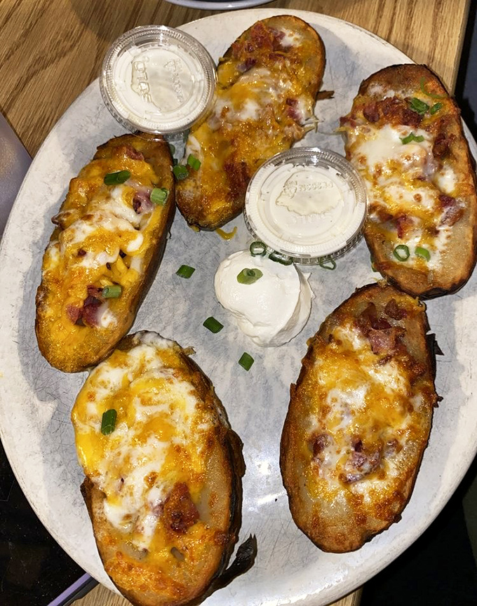 Loaded potato skins that deliver on their promise: crispy vessels overflowing with melted cheese, bacon bits, and a sprinkle of green onion panache.
