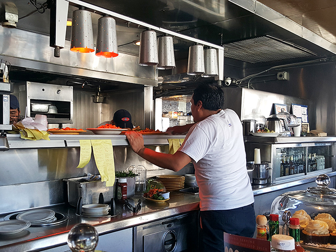 Where the magic happens &ndash; line cooks orchestrating the breakfast symphony with practiced precision and just enough organized chaos.