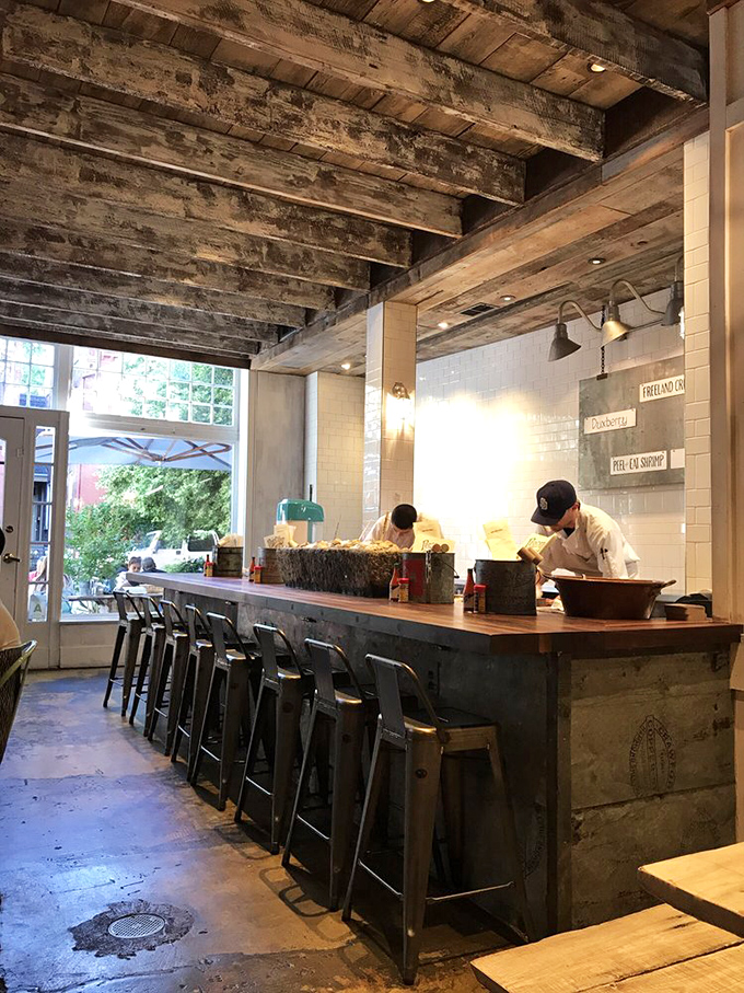 Behind this rustic bar, seafood magic happens &ndash; where oysters are shucked with the precision of a Swiss watchmaker.