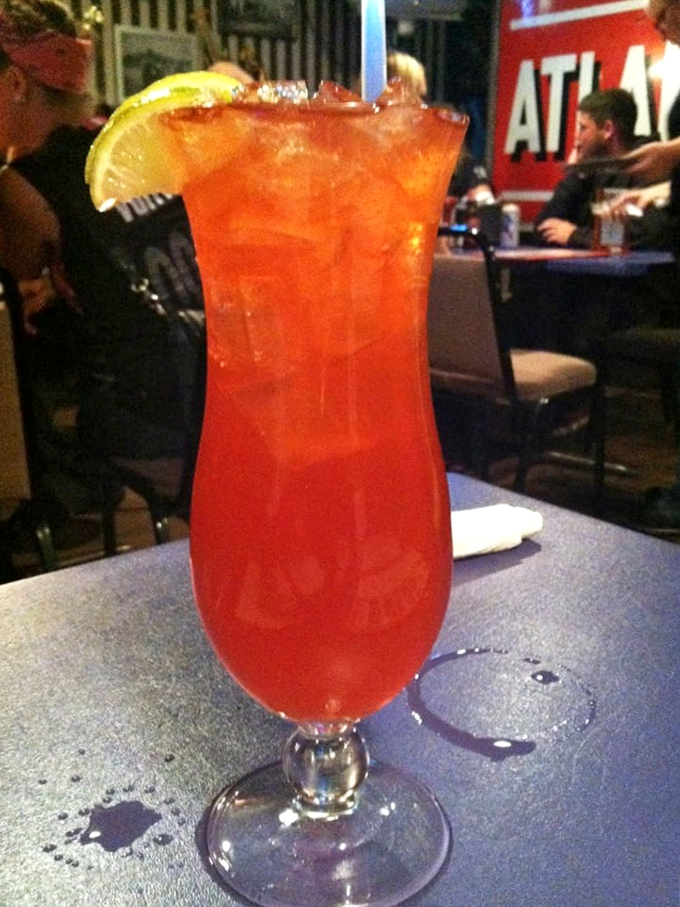 A rum punch that glows like a tropical sunset, promising vacation vibes even if you're just playing hooky from Wednesday's responsibilities.