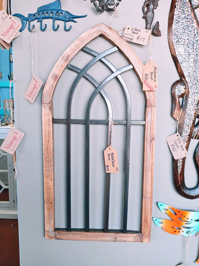 Architectural salvage that transforms ordinary walls into statements. That cathedral-inspired window frame doesn't need stained glass to make spirits soar. 