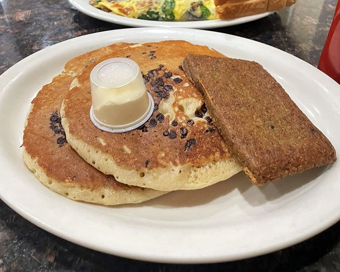 These pancakes aren't just breakfast, they're edible pillows of joy. The butter cup on top is basically the cherry on this morning sundae.