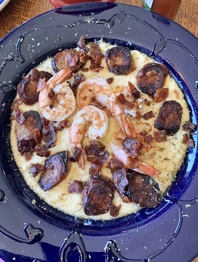 Shrimp and grits elevated to an art form. That creamy, cheesy base cradles seafood like it was born to do it.