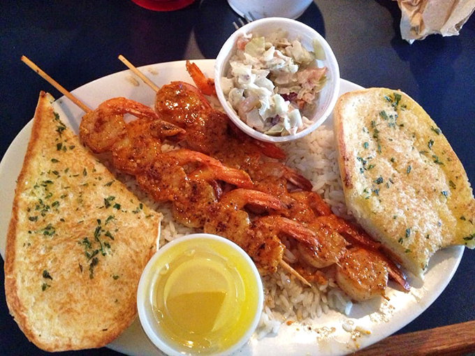 Skewered shrimp that's been kissed by fire, served with garlic bread for sopping up all that buttery, seasoned goodness.