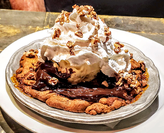 Dessert architecture at its finest &ndash; a warm cookie foundation supporting melting ice cream, whipped cream, and candied pecans in perfect structural harmony.