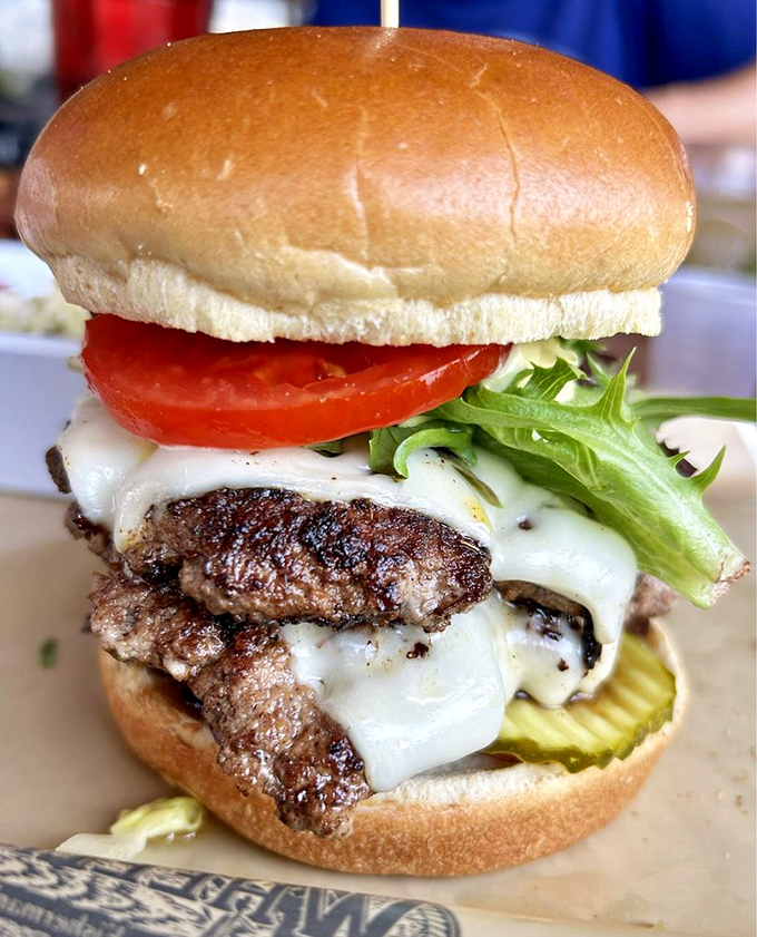 This isn't just a burger; it's a masterclass in proper melted cheese technique. The pickle lurking underneath is the surprise supporting character in this flavor story.