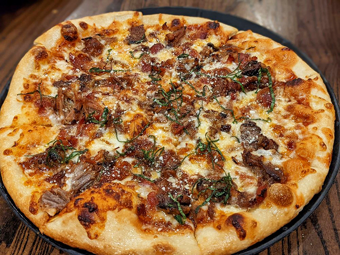 This isn't just pizza&mdash;it's a circular canvas where smoky meat, melted cheese, and fresh herbs come together in perfect harmony.