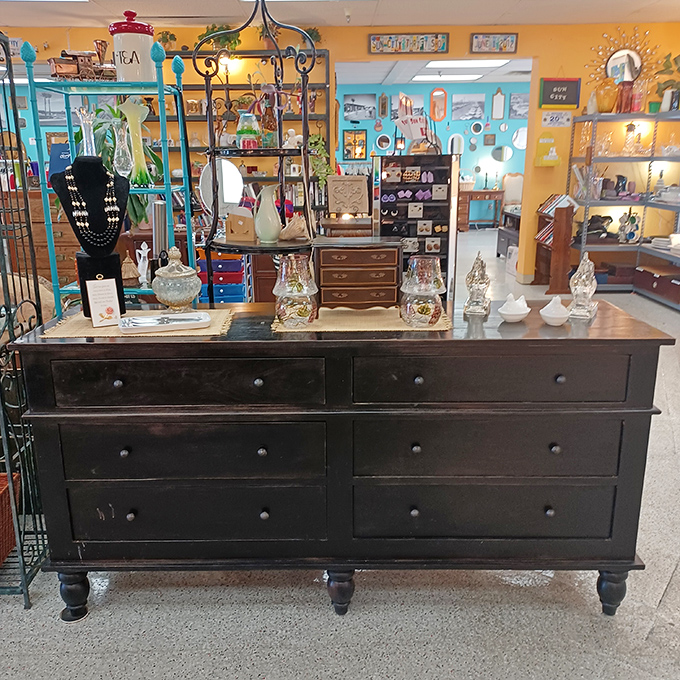 This isn't just furniture; it's functional art. Dark wood dresser with enough storage to hide evidence of your other thrift store addictions.