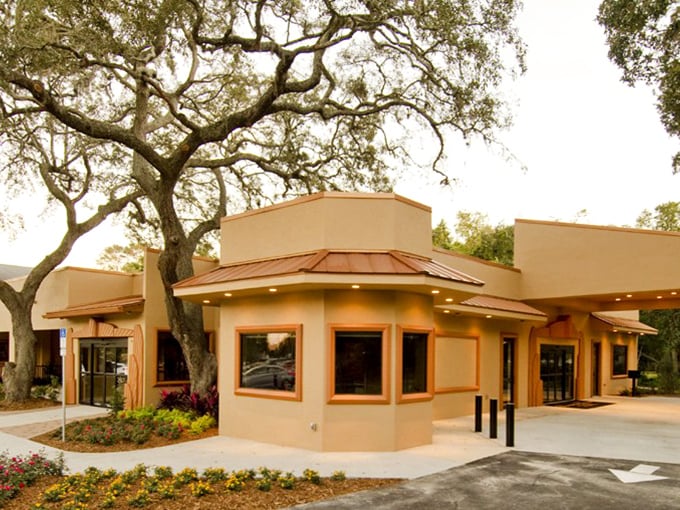 This sandy-hued building nestled among oak trees represents Mount Dora's commitment to blending nature with thoughtful architecture.