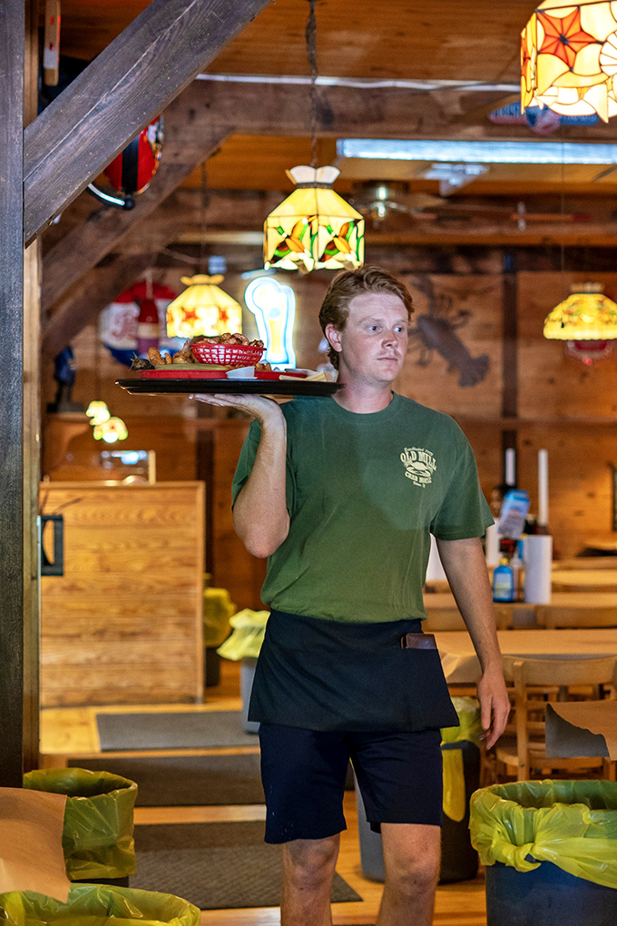The servers navigate the wooden dining room like seafood sommeliers, delivering trays of oceanic treasures with practiced precision.