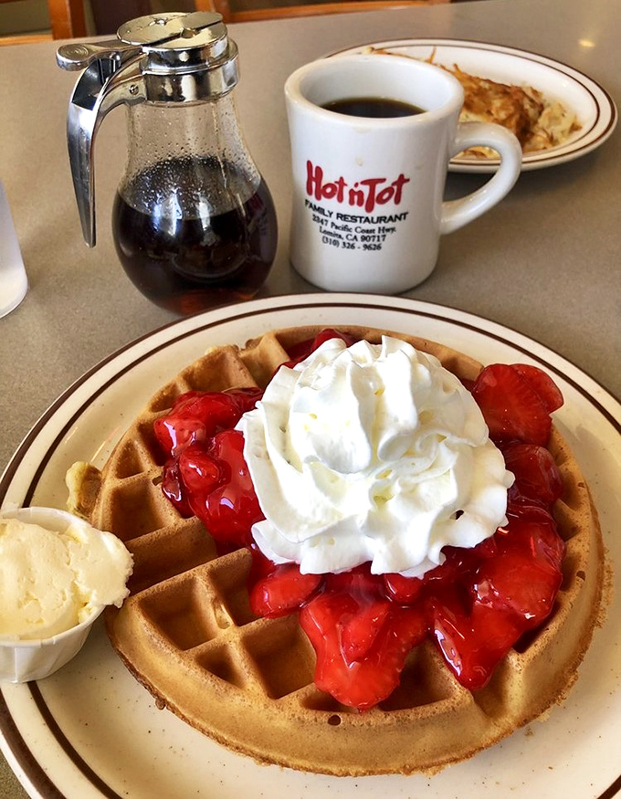 Strawberry waffle perfection: crisp edges, tender center, crowned with berries and cream. Dessert masquerading as breakfast, and nobody's complaining.