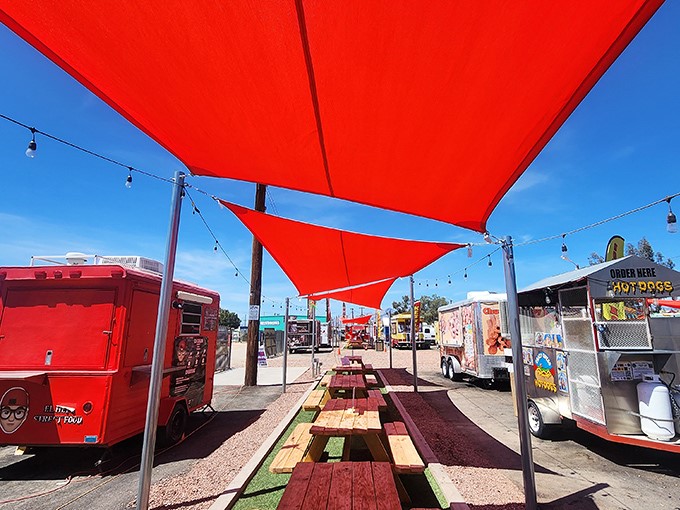 Bright red canopies create an oasis of shade where hungry shoppers can rest between bargain hunts and sample a world of flavors.
