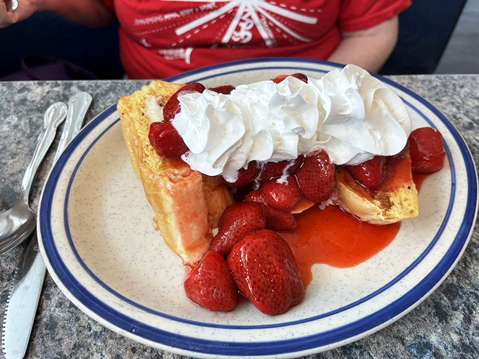 Strawberry-topped French toast that makes you question why people eat anything else for breakfast. Whipped cream applied with joyful abandon.