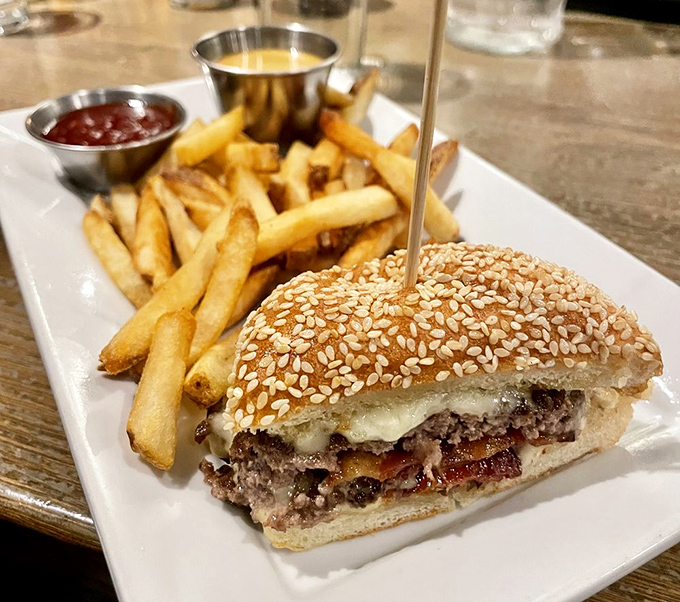 This isn't just a burger; it's an architectural marvel with a sesame seed roof. The kind of sandwich that requires strategic planning before each bite.