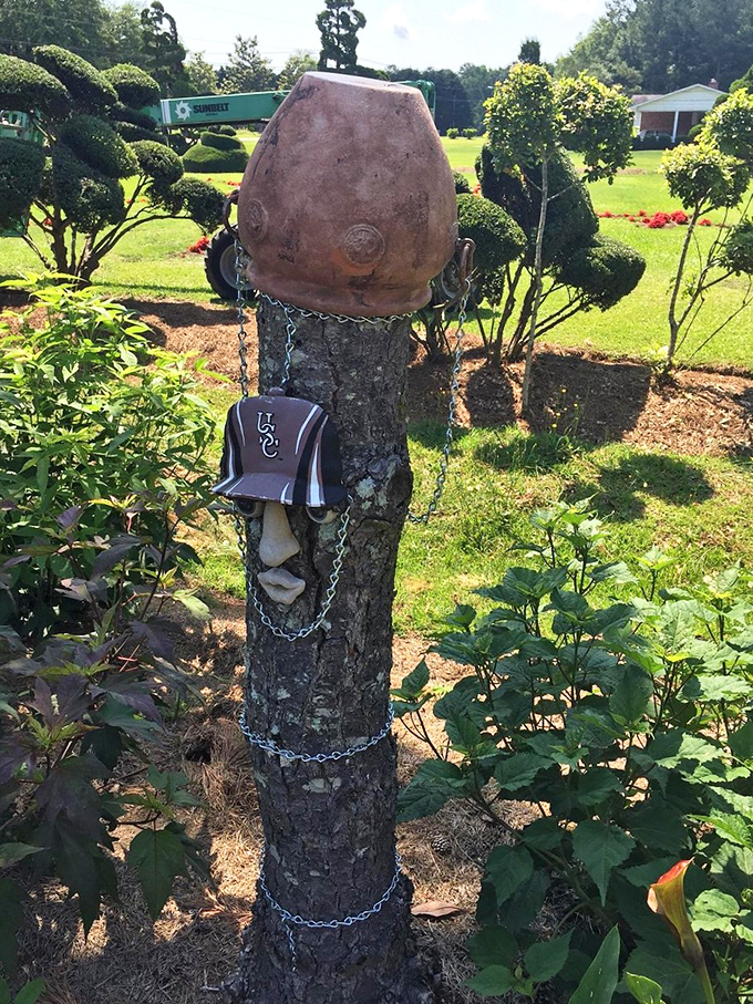 Talk about upcycling! This tree stump transformed into art proves that in creative hands, nothing goes to waste in this remarkable garden.
