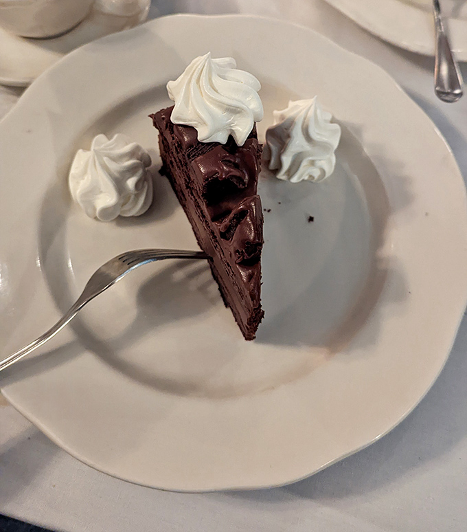 Triple chocolate cake that doesn't just satisfy your sweet tooth &ndash; it throws a party for it. Those whipped cream dollops are the backup dancers.