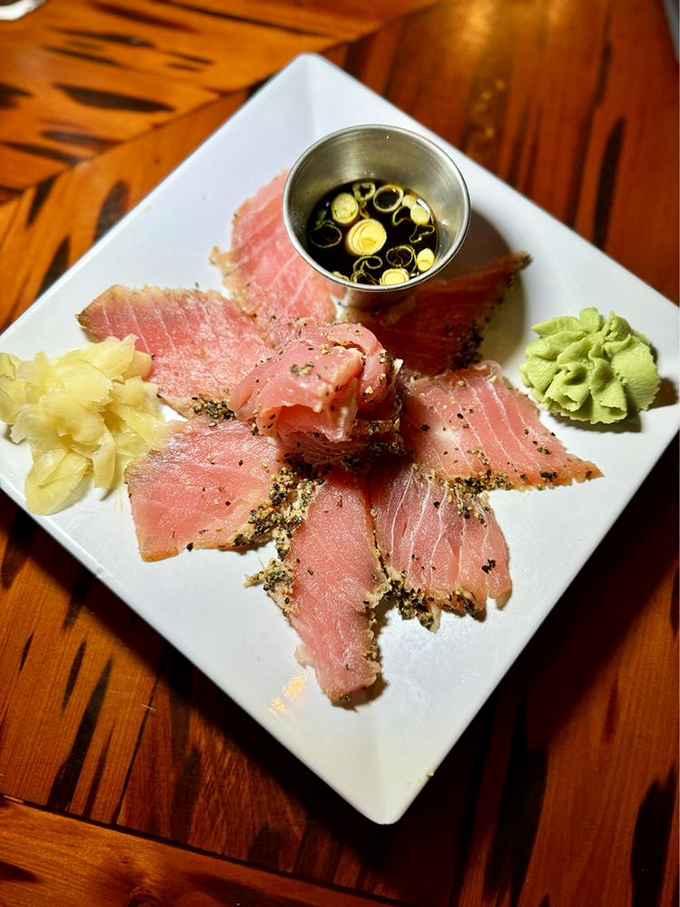 Tuna tataki: ruby-red slices arranged like a marine jewelry display. That wasabi dollop stands guard, daring you to take more than your share.