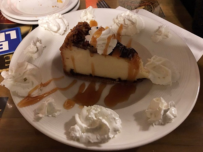 Turtle cheesecake surrounded by whipped cream islands and caramel rivers—proof that saving room for dessert is always the right decision.