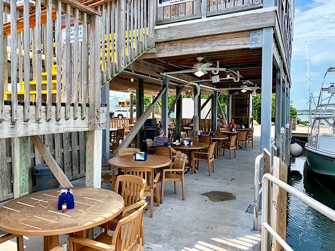 Dockside dining under weathered wood. The boats bobbing nearby aren't just decoration&mdash;they're your meal's origin story.