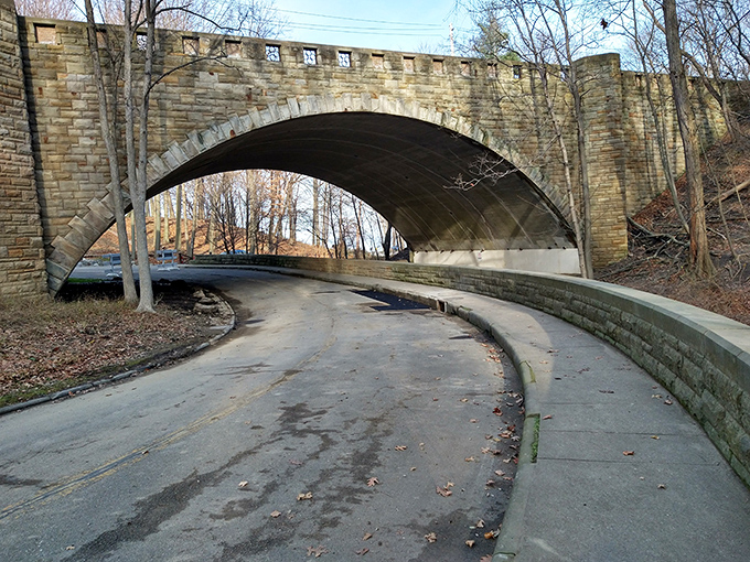 This historic stone arch isn't just functional infrastructure; it's a portal between everyday life and lakeside escape.