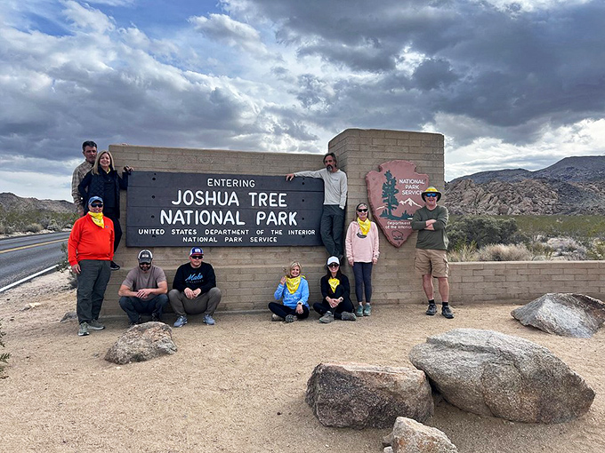Joshua Tree National Park's entrance sign serves as the ultimate group photo backdrop, where hikers gather before venturing into nature's most surreal sculpture garden.