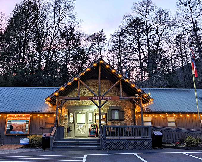 The Visitor Center glows at dusk like a woodland lighthouse, beckoning travelers with the promise of maps and insider tips.