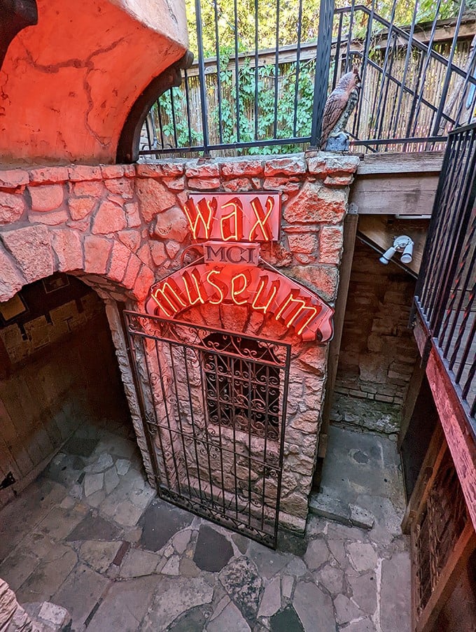 The neon "Wax Museum" sign glows ominously above a gated entrance. Like a portal to the uncanny valley, with better lighting.